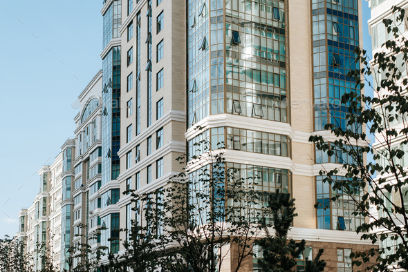 Modern apartment building with glass balconies, exterior. Close-up ...