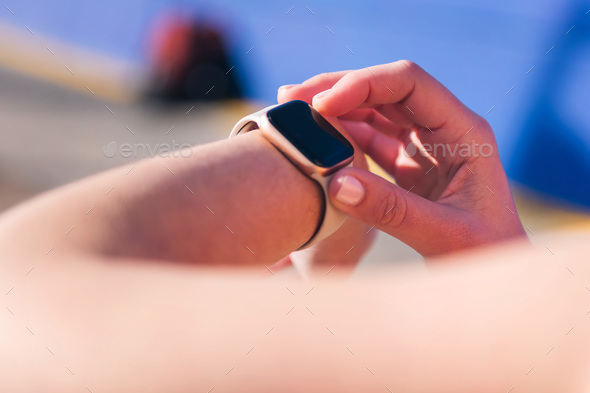 arm of a woman wearing a smart watch outdoors Stock Photo by Raul_Mellado