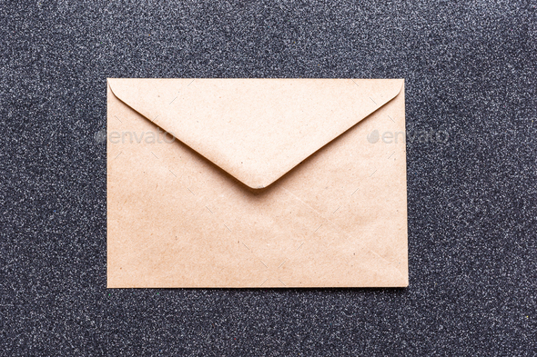 Closed brown craft envelope on dark background. An envelope for your ...