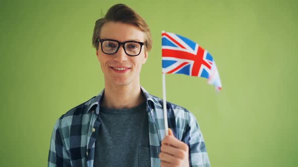 Portrait of Proud Englishman Holding Flag of England Smiling Looking at ...