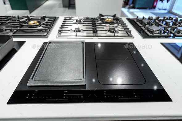 Modern cooking stoves on display in the store Stock Photo by FabrikaPhoto