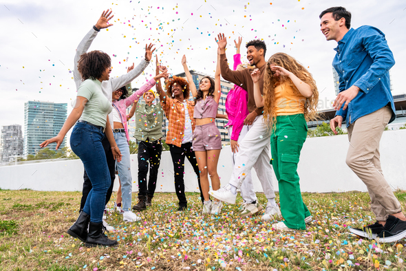 Happy playful multiethnic group of young friends bonding outdoors Stock ...