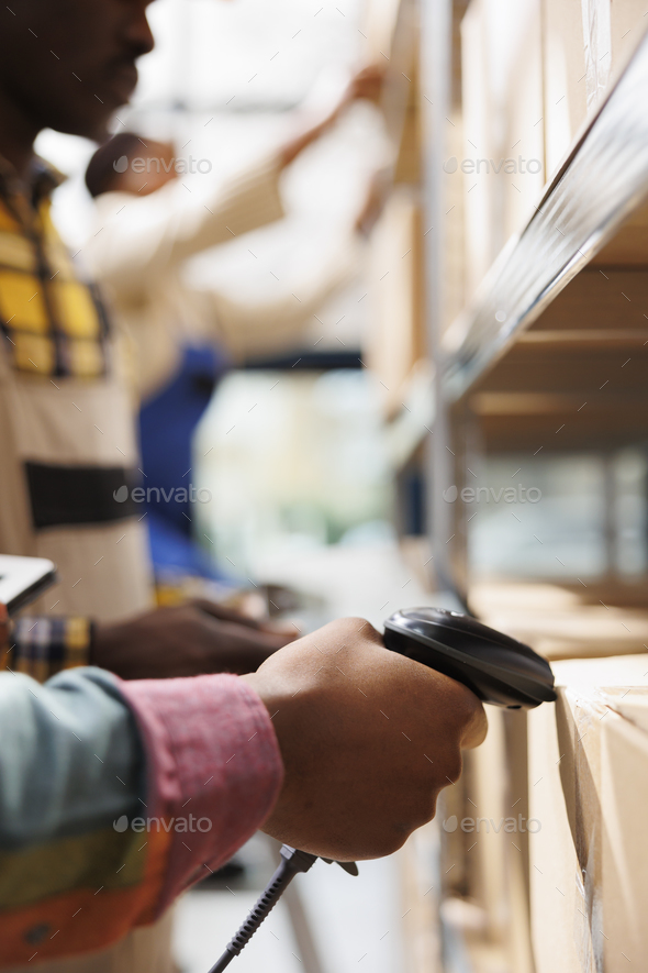 African american postal worker hand scanning parcel in warehouse Stock ...