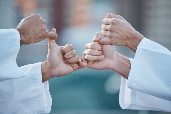 Hands, karate and grip with sports people fighting outdoor in a ...