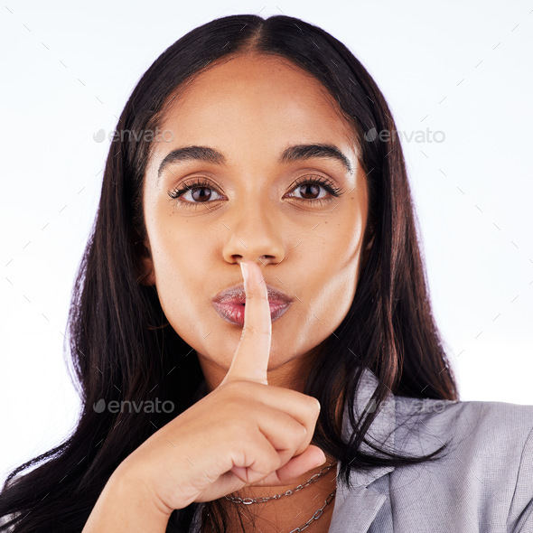 Secret, portrait and woman with finger on lips in studio, white ...