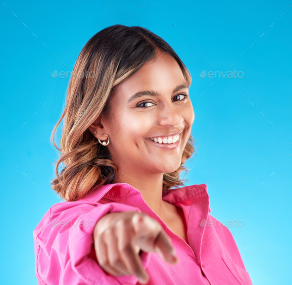 Pointing finger, smile and portrait of woman in studio to select ...