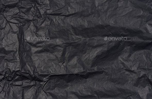 Crumpled sheet of black parchment paper, abstract background Stock ...