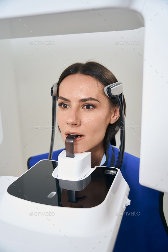 Charming lady undergoes 3D scanning procedures on modern equipment ...