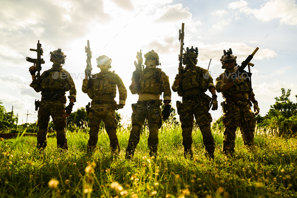 Smart teamwork of soldiers running forward and attacking enemy during ...