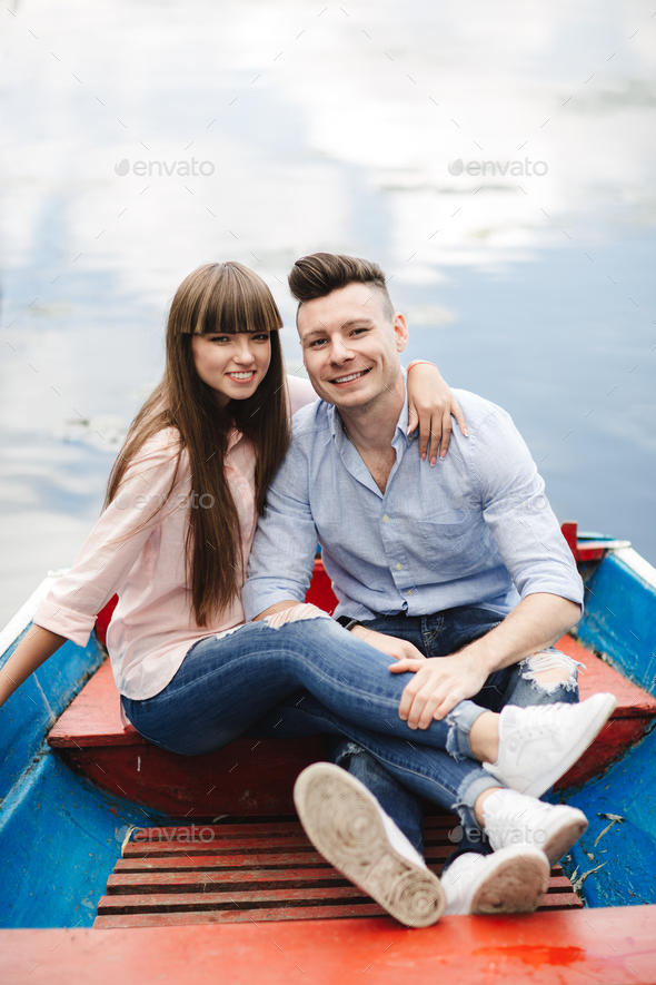 A couple riding a blue boat on a lake. romance. emotional couple. funny ...