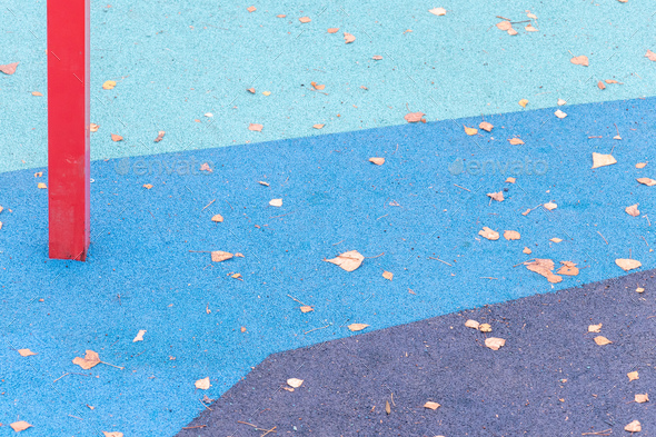 Blue rubber playground with red bars and fallen leaves: Active outdoor ...
