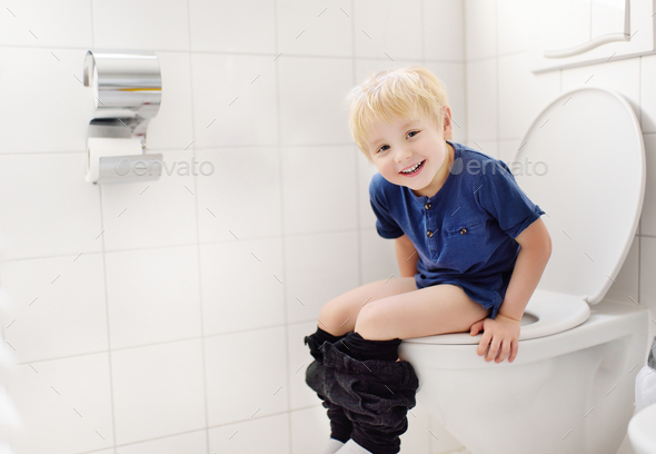 Cute little boy in restroom. Toddler child is training use toilet ...