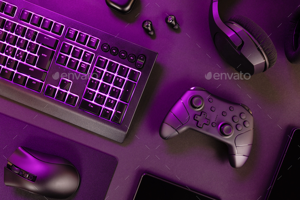 Purple lit keyboard amidst various devices Stock Photo by kjekol ...