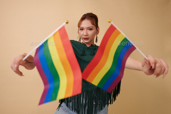 Transgender Woman with Rainbow Flags Stock Photo by DragonImages ...
