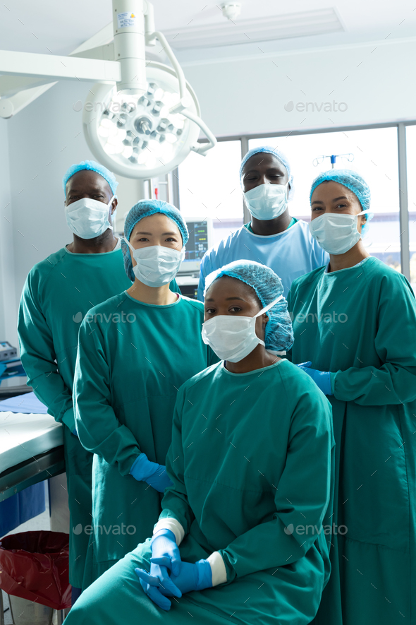 Vertical portrait of diverse group of surgeons ready for surgery in ...