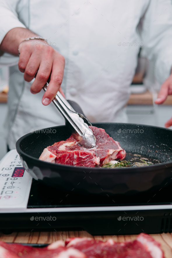 cooking steaks in a pan. cooking beef at the culinary master class ...