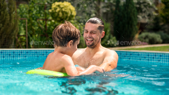 Dad and son in the pool Stock Photo by frimufilms | PhotoDune