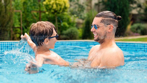 Dad and son in the pool Stock Photo by frimufilms | PhotoDune