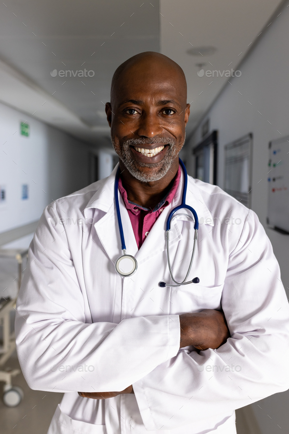 Portrait of happy african american male doctor wearing lab coat in ...
