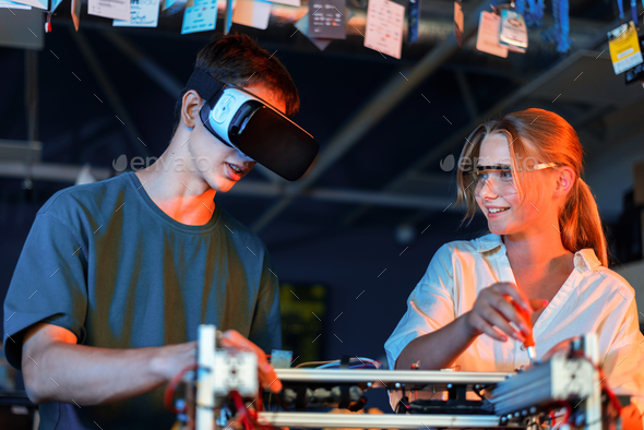 Teens doing experiments in robotics in a laboratory Stock Photo by ...