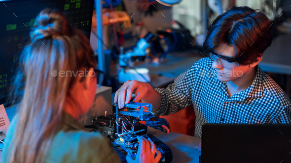 Teens doing experiments in robotics in a laboratory Stock Photo by ...