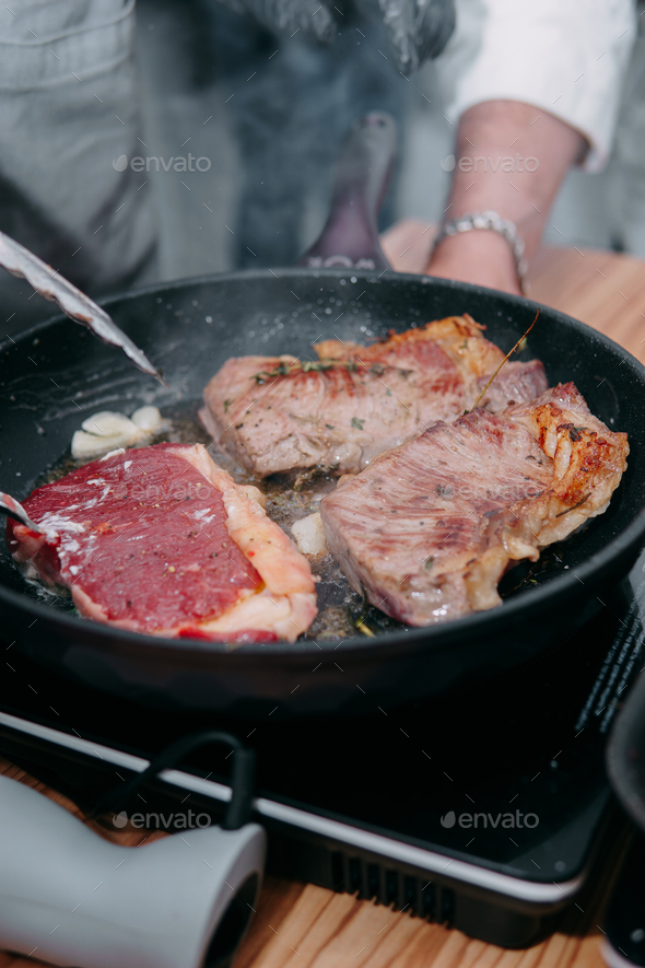 cooking steaks in a pan. cooking beef at the culinary master class ...