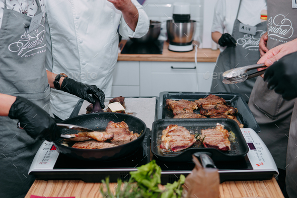 cooking steaks in a pan. cooking beef at the culinary master class ...
