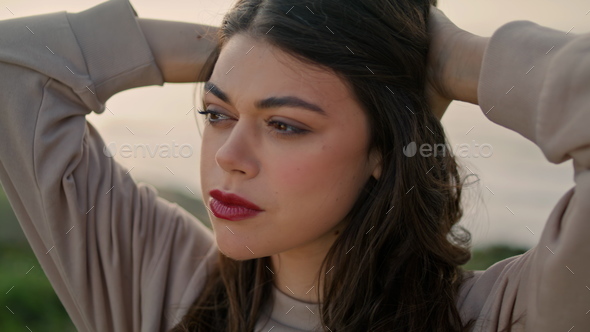 Portrait confident model looking camera at seacoast. Girl posing on ...