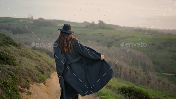 Back view woman traveler walking rural road. Girl going down path ...