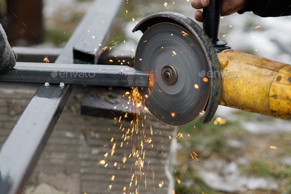 Cutting metal with angle grinder machine. Close up of circular grinder ...