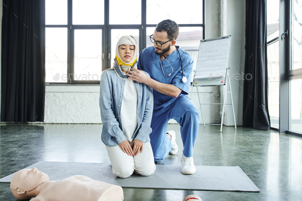 medical instructor with stethoscope, in eyeglasses and uniform, putting ...