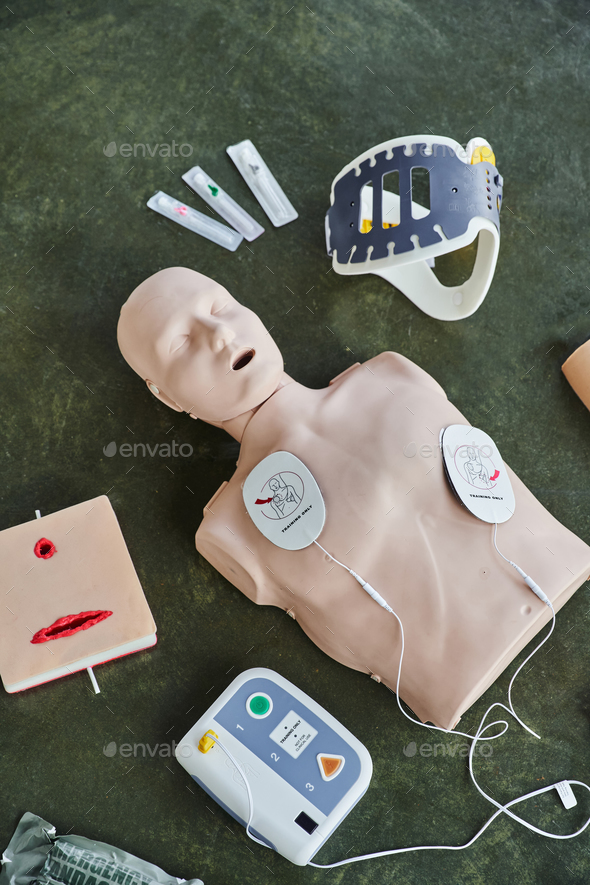 top view of CPR manikin, automated external defibrillator, wound care simulator, neck brace ...