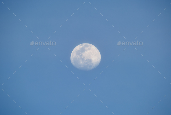 Bright full moon on blue sky during daylight. Round lunar disc Stock ...
