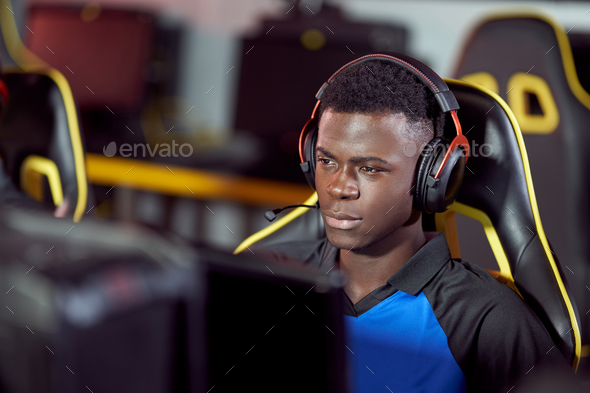Portrait of focused african cybersport male gamer wearing headphones ...