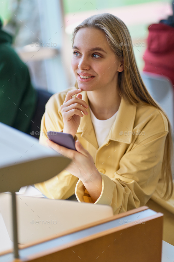 Teenage girl gen z student using cell phone looking away. Vertical ...