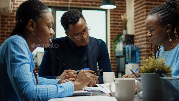 Company employees reviewing documents Stock Photo by DC_Studio | PhotoDune