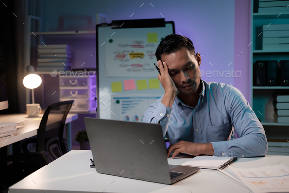 Tired and exhausted young Asian businessman feeling upset and tired ...