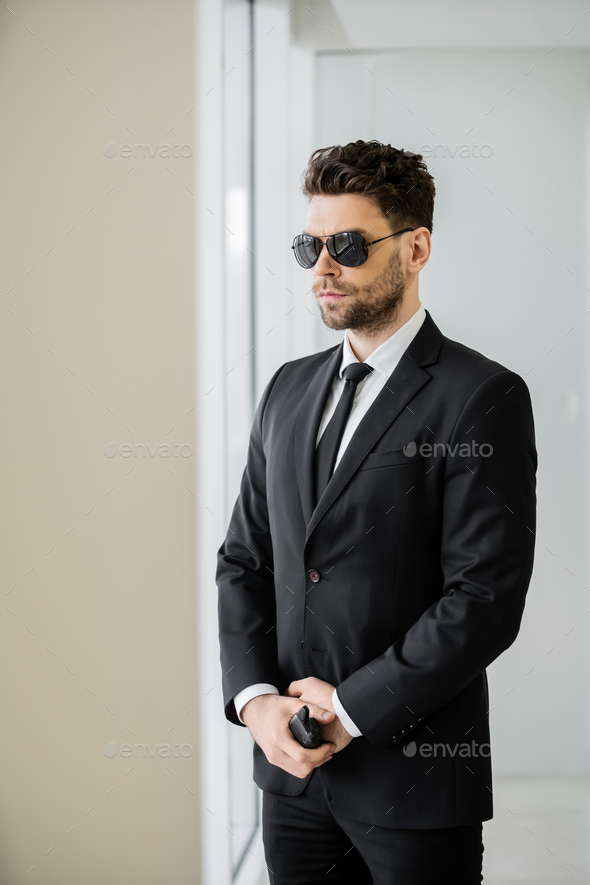 surveillance, bodyguard standing with walkie talkie, man in sunglasses ...