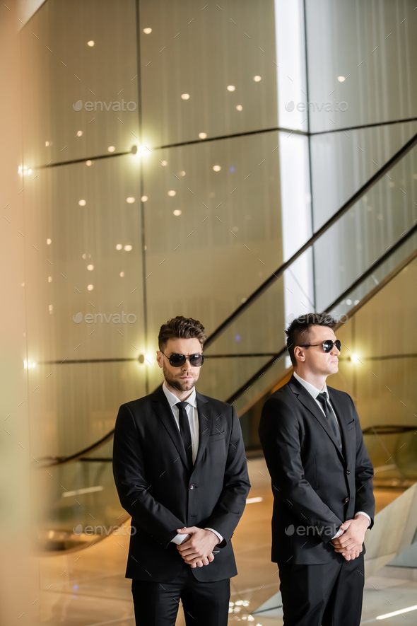 security management of hotel, two handsome men in formal wear and ...
