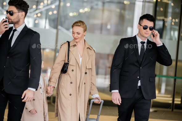 private security concept, two bodyguards in suits and sunglasses ...
