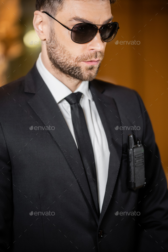 handsome bodyguard, security guard in suit with tie and sunglasses ...
