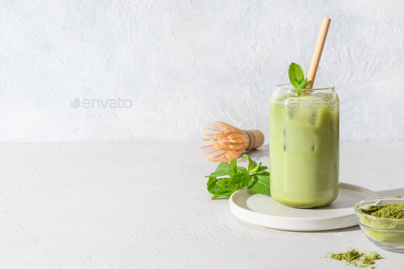 Iced Green matcha tea in glass garnish mint isolated on white. Close up ...