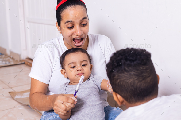 mother and children making a mess with paint Stock Photo by dionisioc1