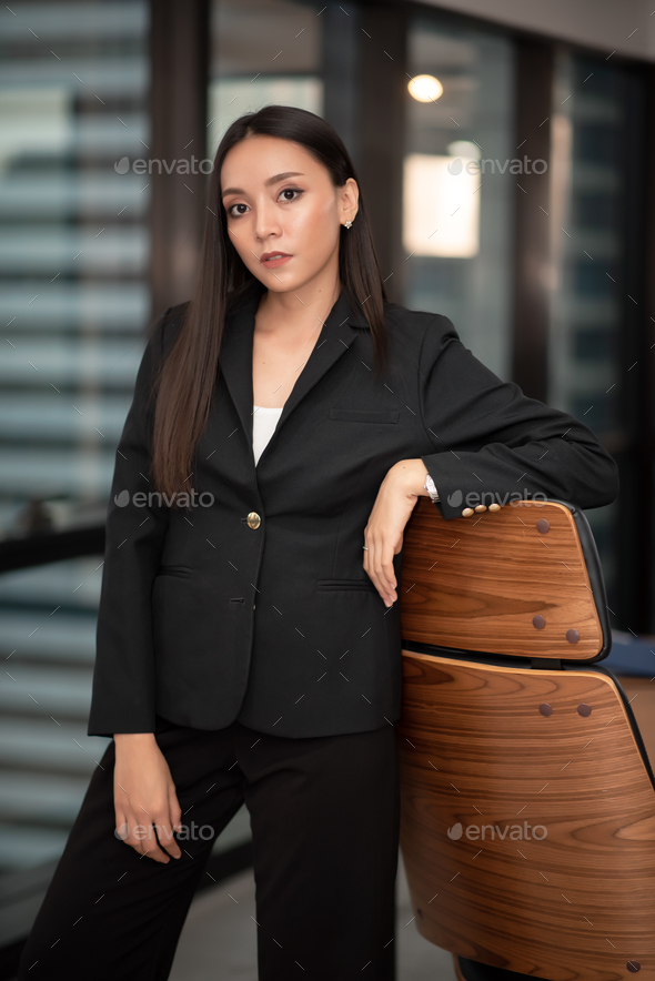 Portrait smart asian business woman in black casual suit in an office ...