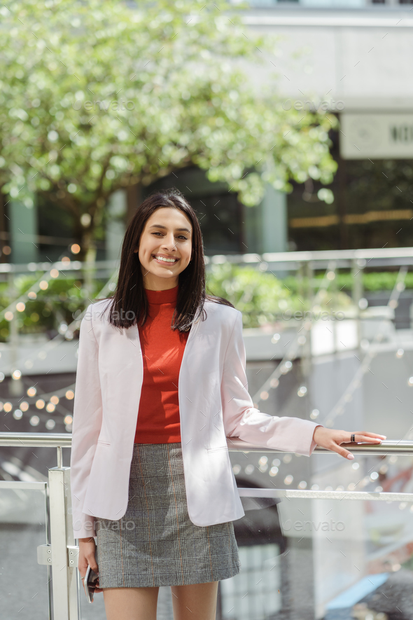 Vertical view of beautiful confident Indian woman standing outdoors ...