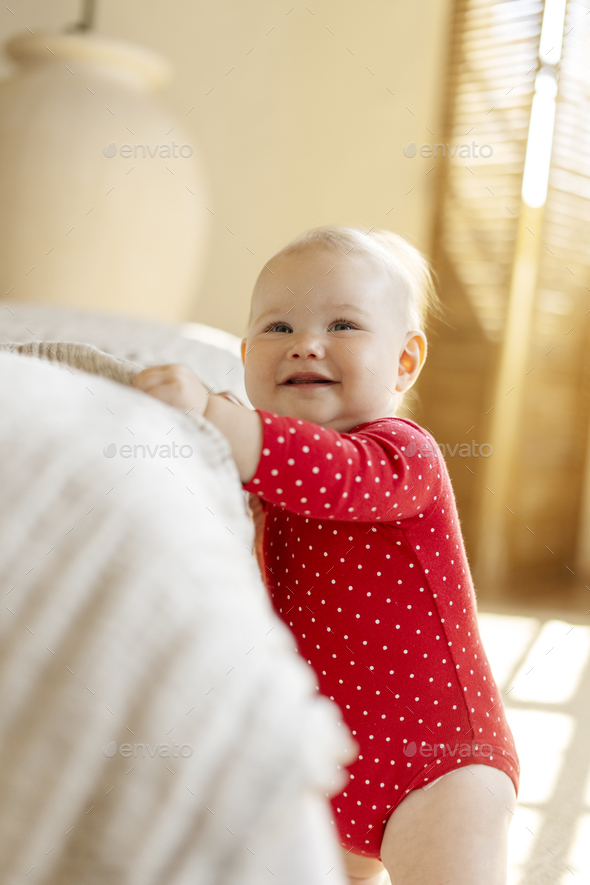Portrait of cute little toddler wearing red baby clothes standing Stock ...