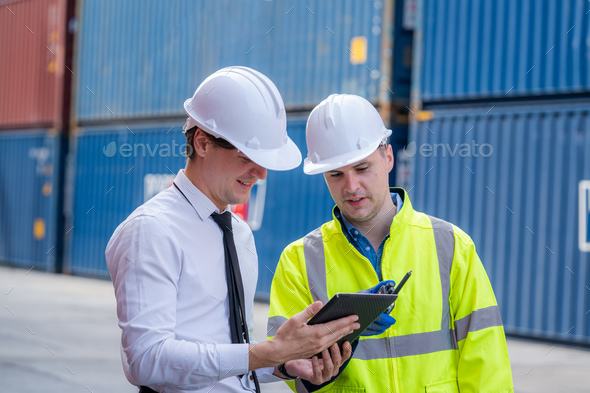 Engineer and inspector working and discuss in shipping container in ...