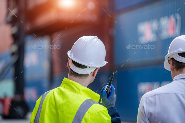 Engineer and inspector working and discuss in shipping container in ...