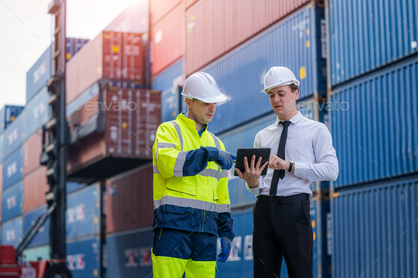 Engineer and inspector working and discuss in shipping container in ...