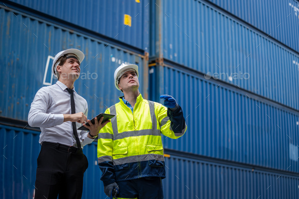Engineer and inspector working and discuss in shipping container in ...